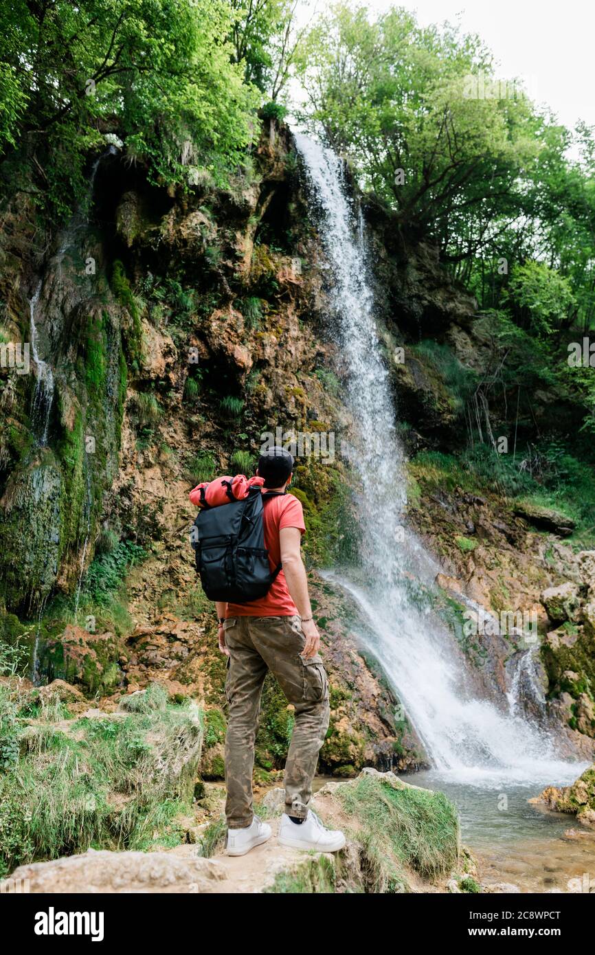 Young male nature explorer by the waterfalls Stock Photo - Alamy