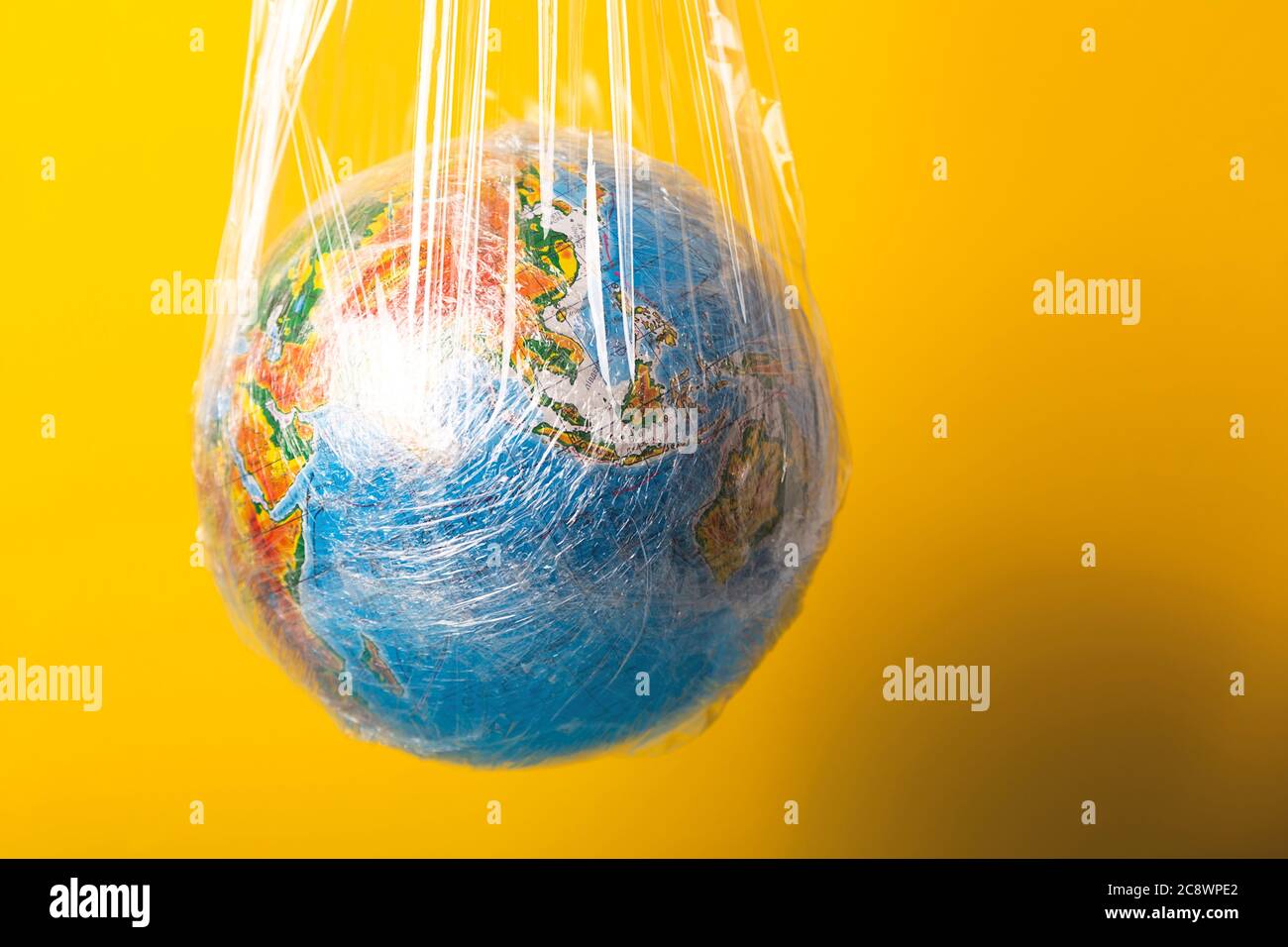 The planet earth is wrapped in plastic. Ecological disaster concept ...