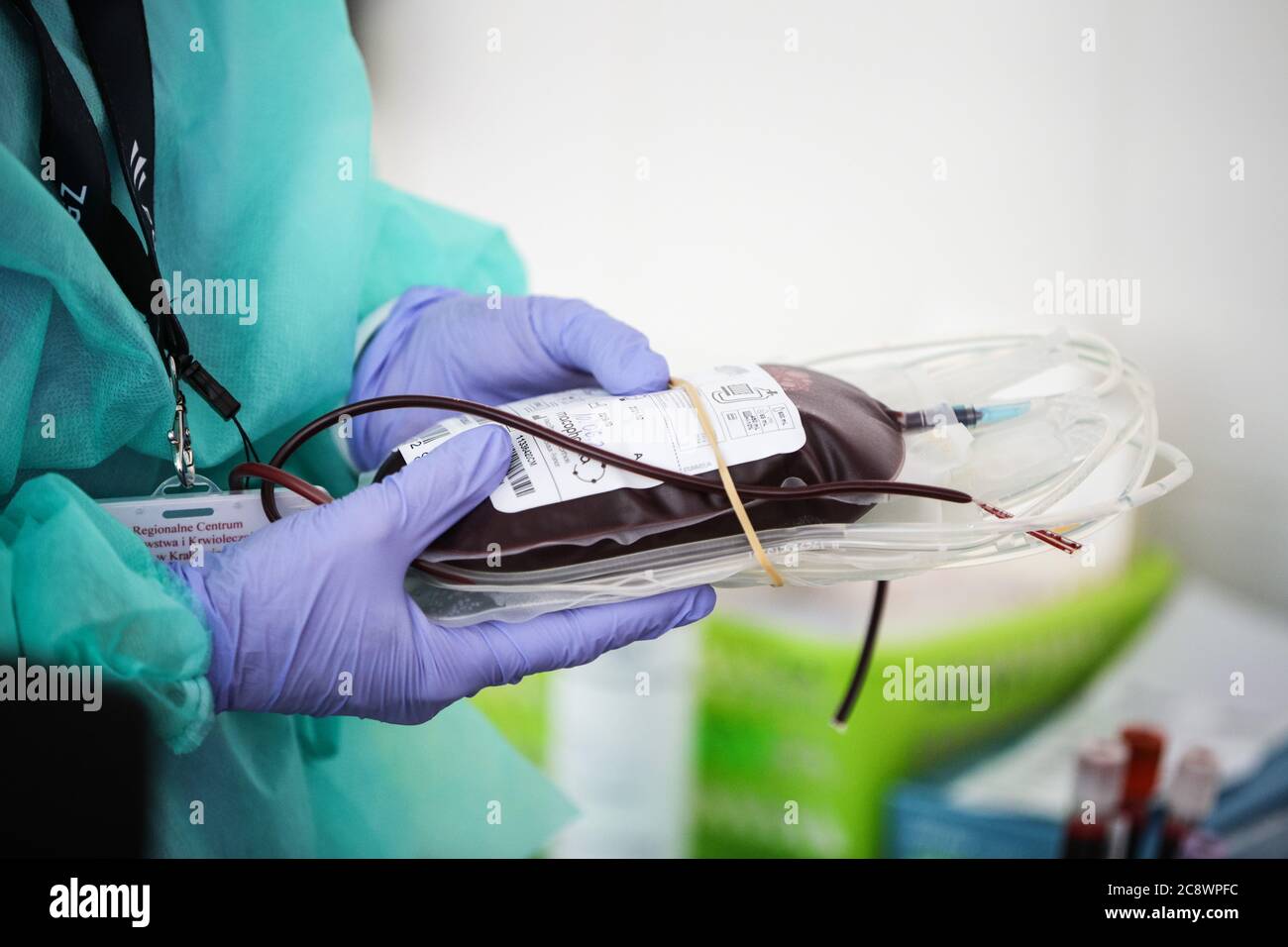 Container with donor blood seen in the hands of member of the medical ...