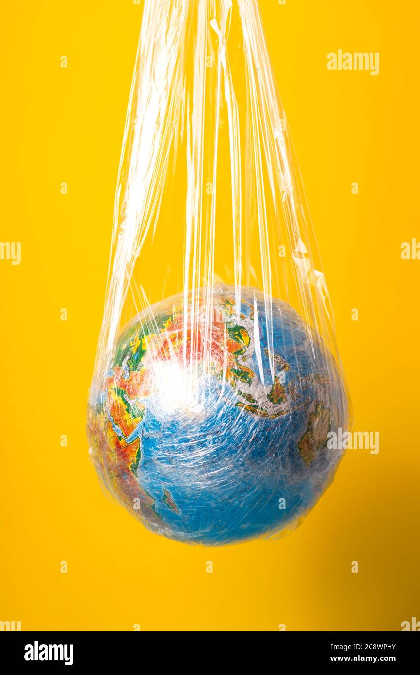 The planet earth is wrapped in plastic. Ecological disaster concept ...