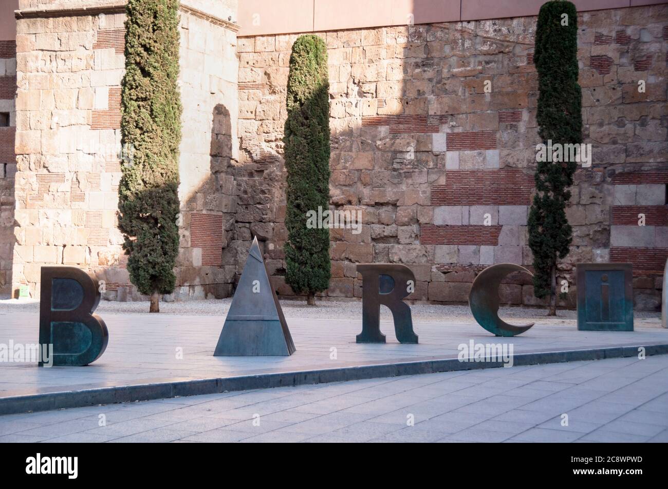 The wall of Barcino, a Roman wall in Barcelona, fronted by an artistic ...