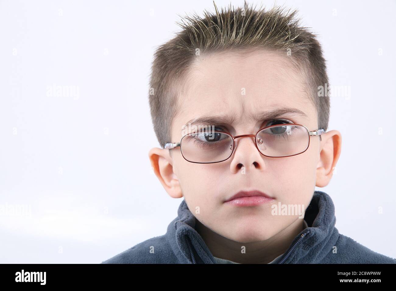 angry young boy on white background Stock Photo - Alamy
