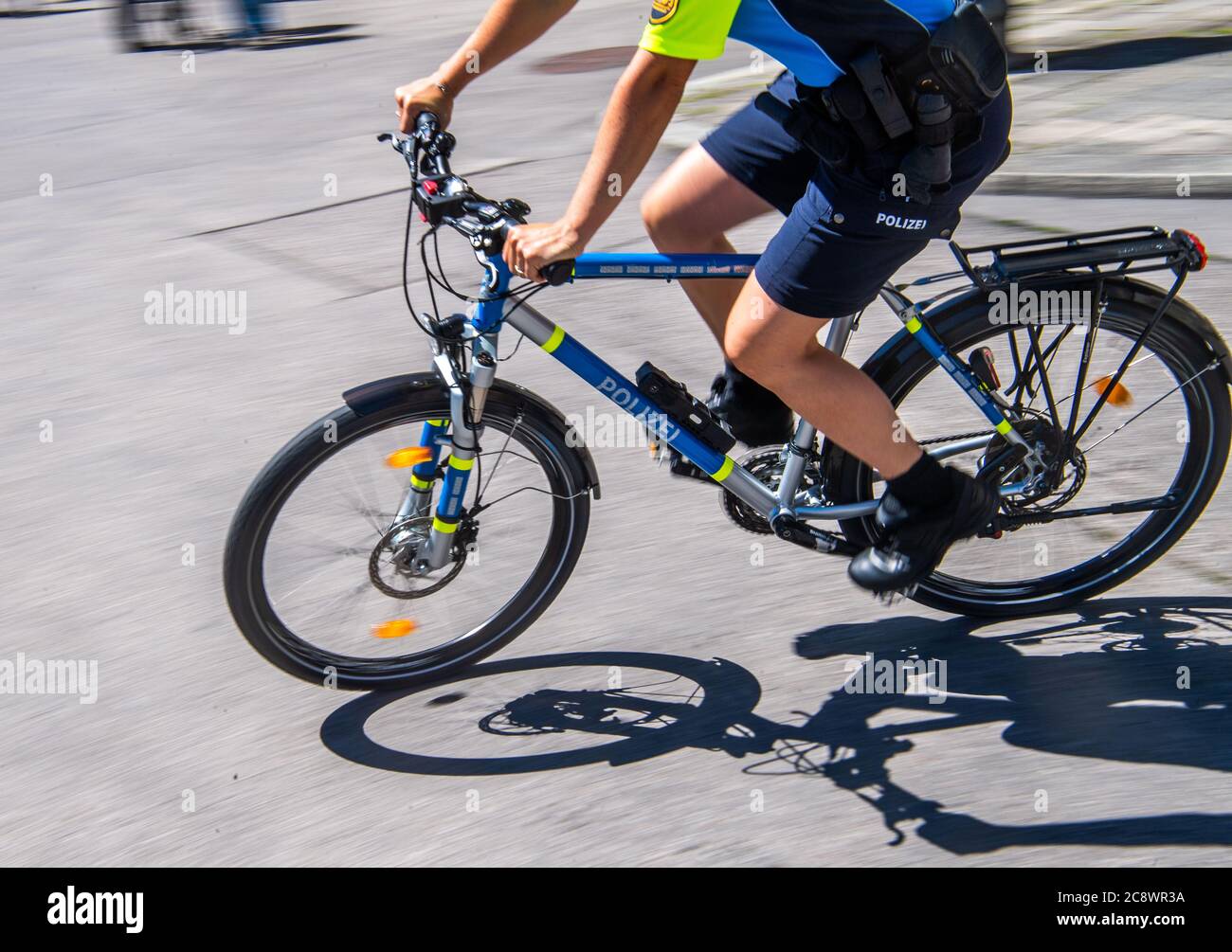 Munich, Germany. 27th July, 2020. A female bicycle police officer rides ...