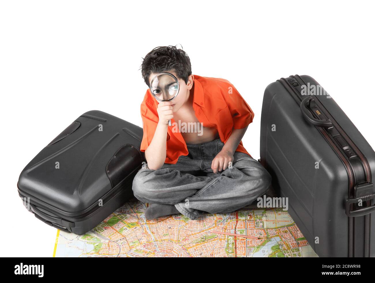 Little boy watching a map on white background Stock Photo - Alamy
