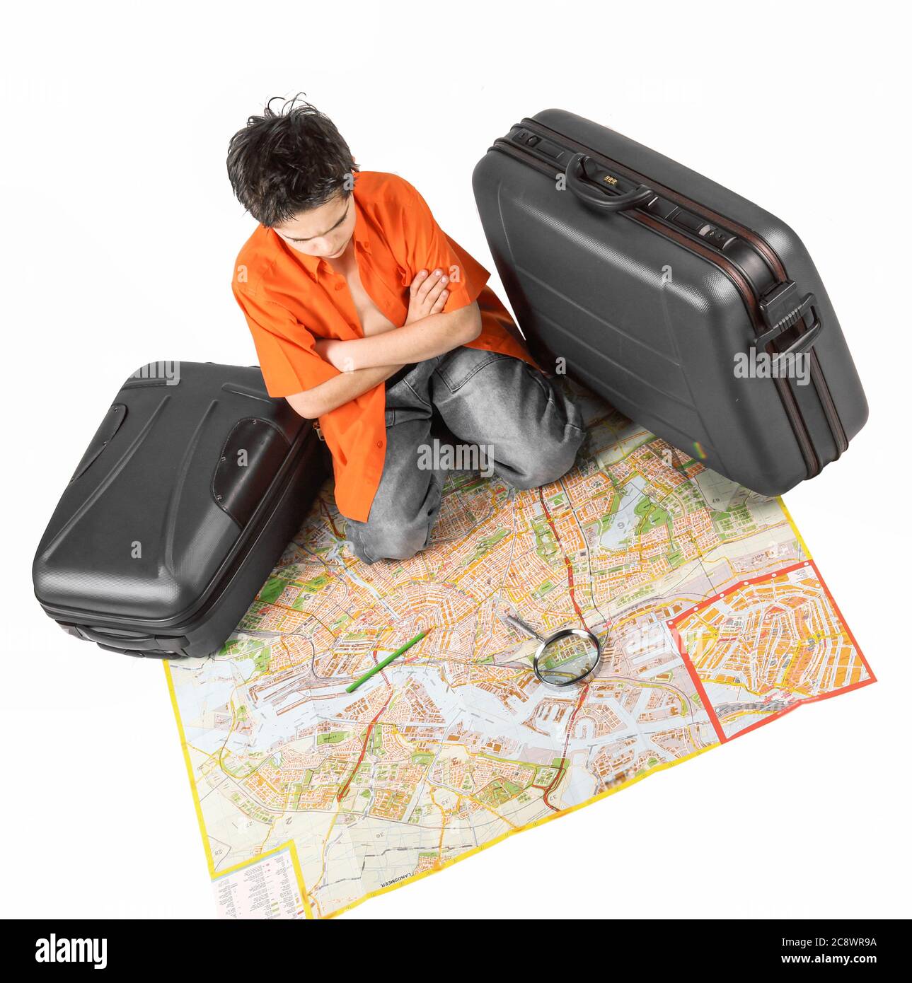 Little boy watching a map on white background Stock Photo - Alamy