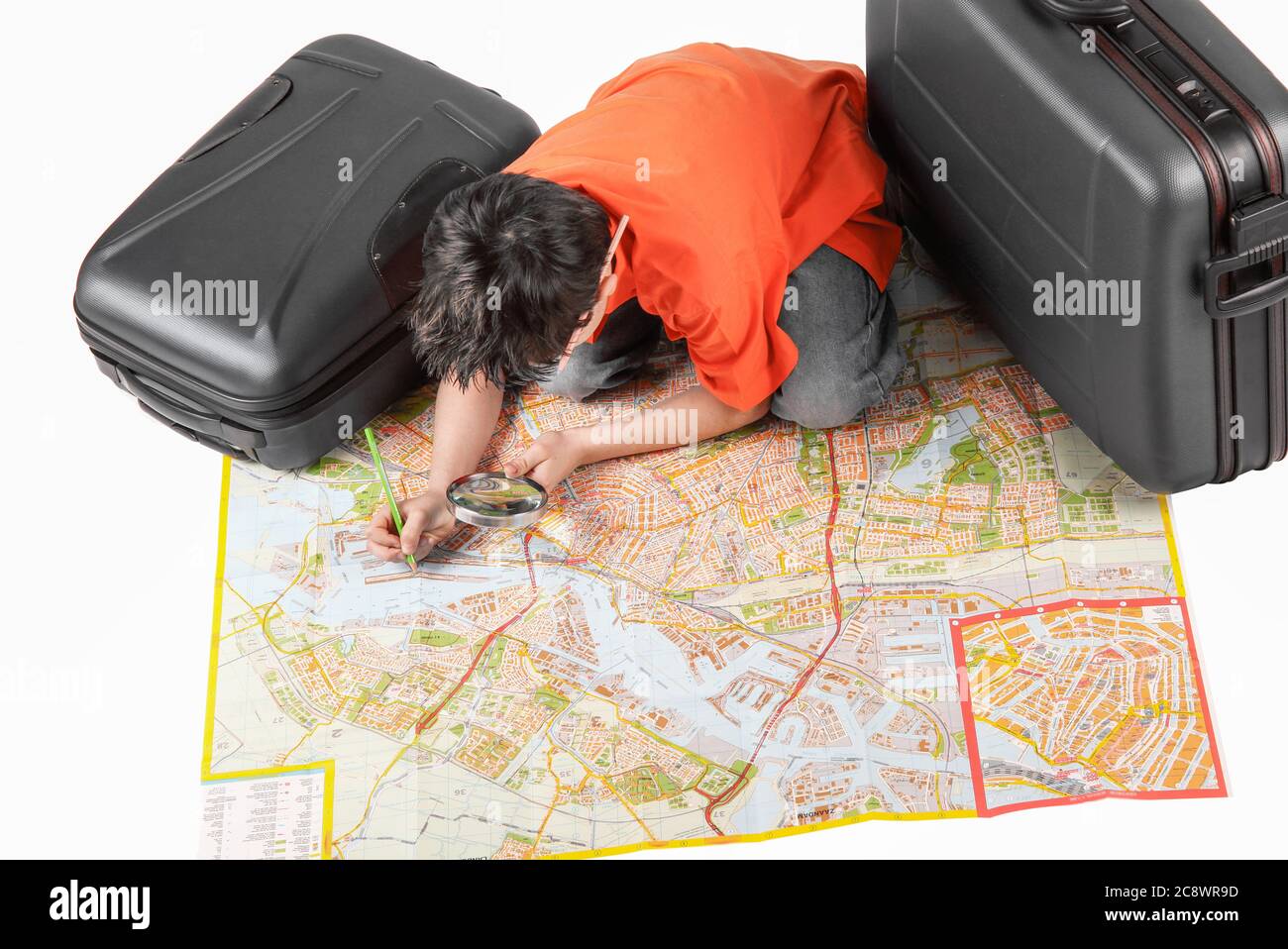 Little boy watching a map on white background Stock Photo - Alamy