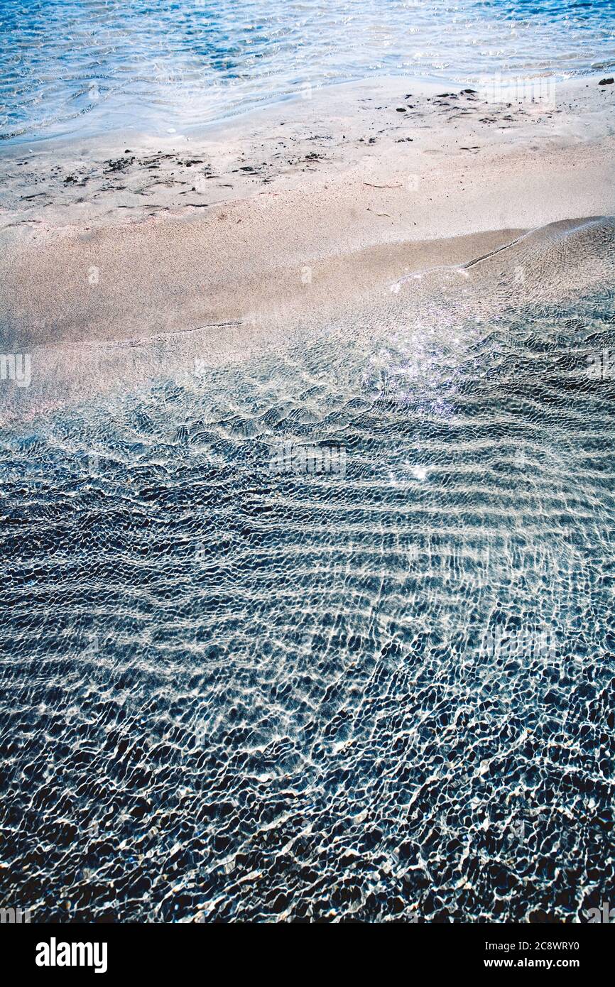 Top view of ripples on the water surface at a beach surrounding a sound ...