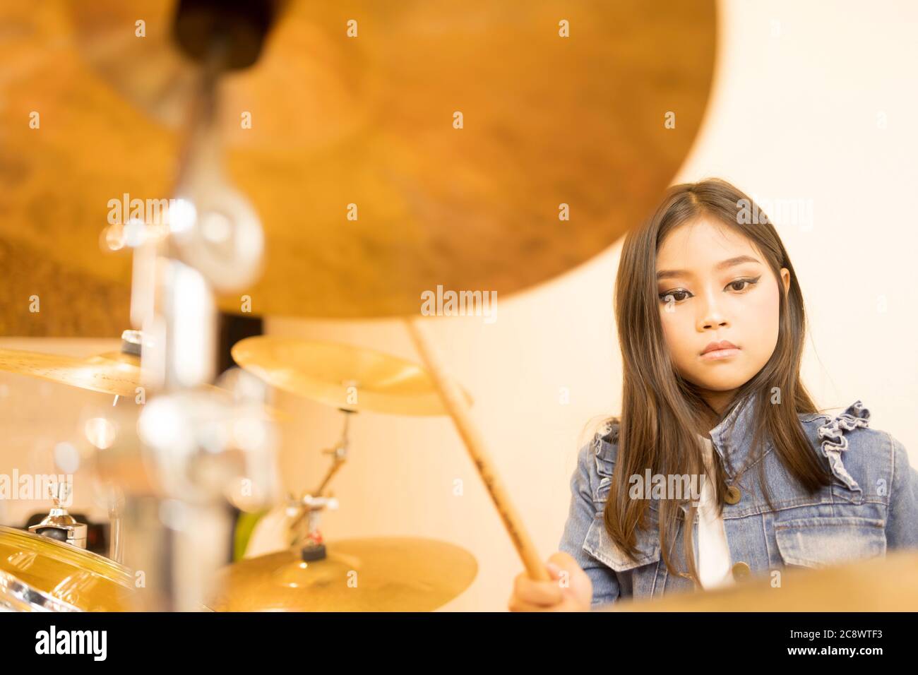 Asian girl playing drum hi-res stock photography and images - Alamy