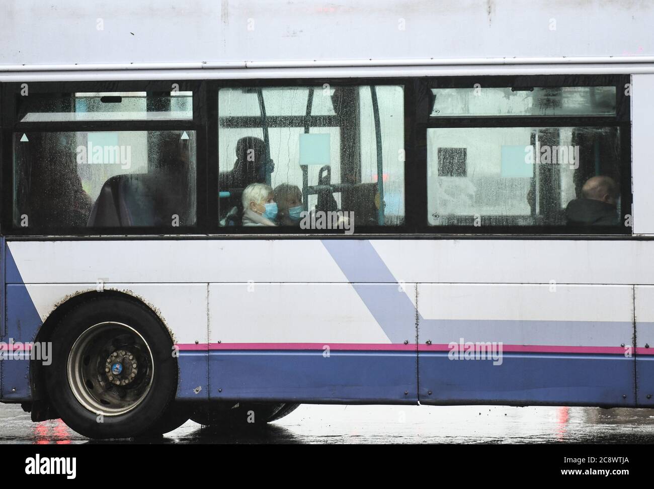 Bus passengers face coverings hi-res stock photography and images - Alamy