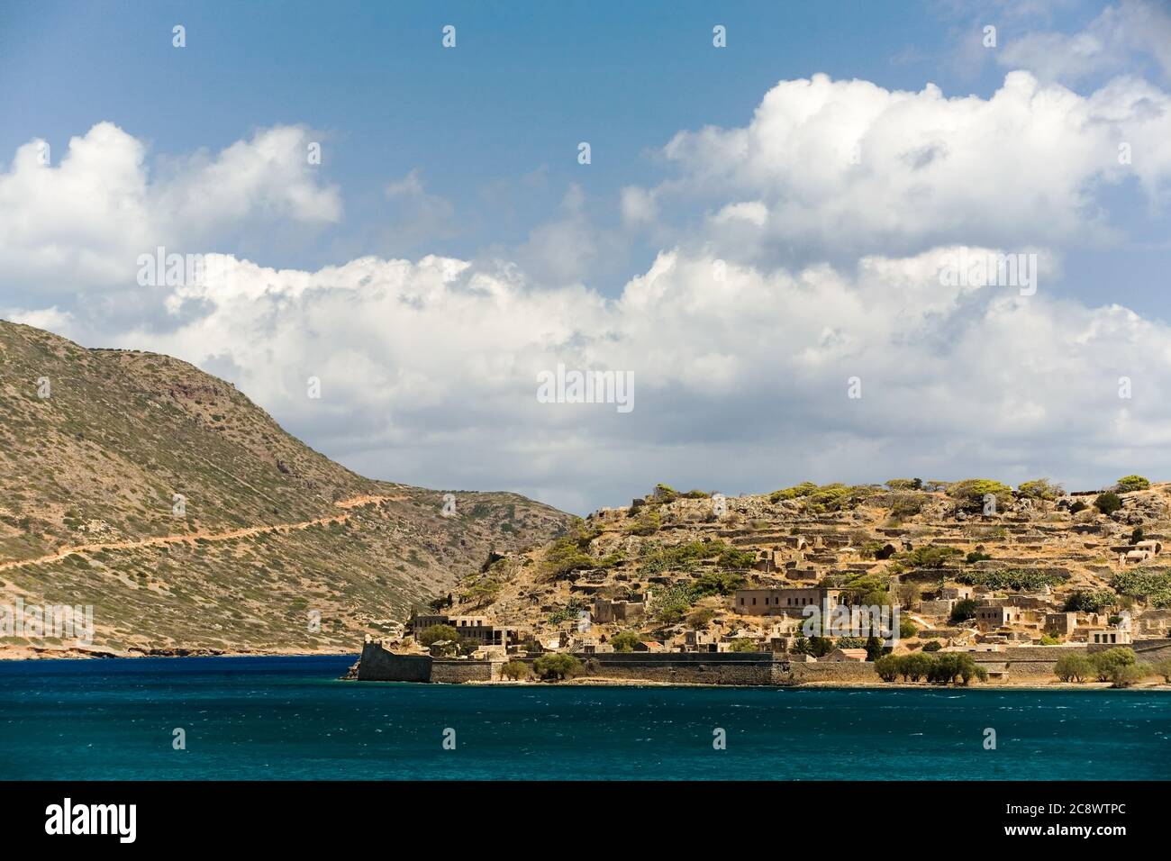 View of the fortress of the Spinalonga island under a cloudy sky in ...