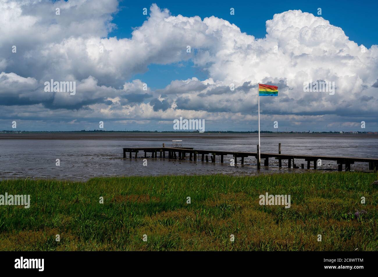 a rainbow flag on a jetty in the wadden sea Stock Photo - Alamy