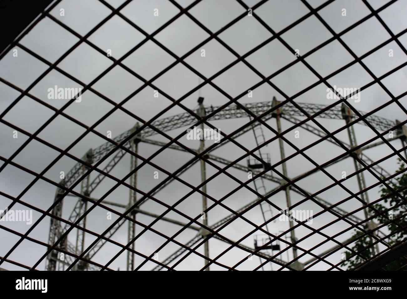 Gasometer through the fence Stock Photo - Alamy