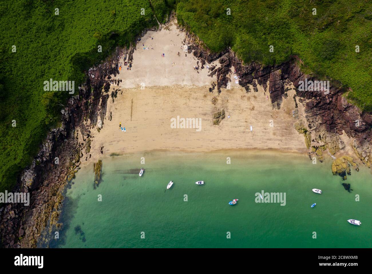 Aerial view of a small, sandy beach in a rocky bay (Watwick Bay ...