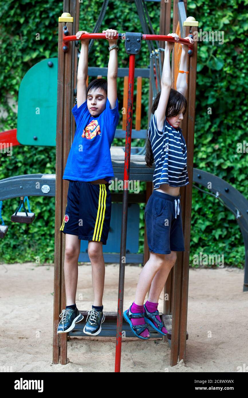 Two boys having a hanging competition Stock Photo - Alamy