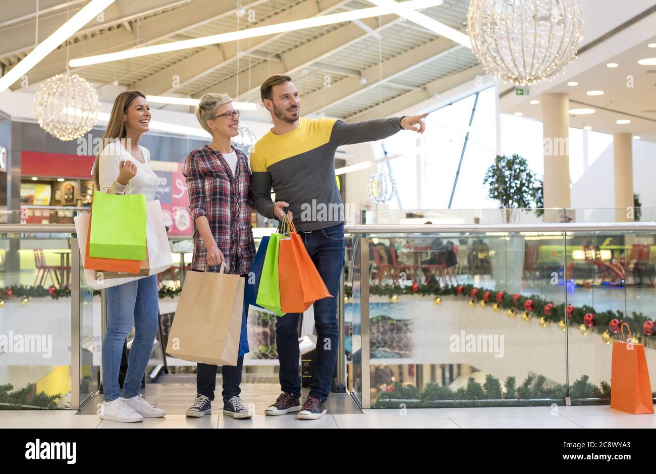 Group of friends doing shopping in the shopping centre Stock Photo - Alamy