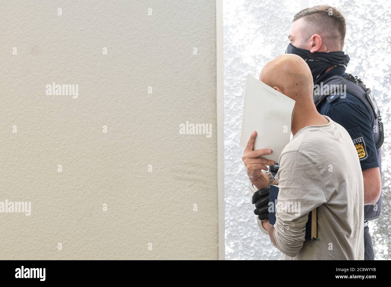 Stuttgart, Germany. 27th July, 2020. The accused is led into the ...