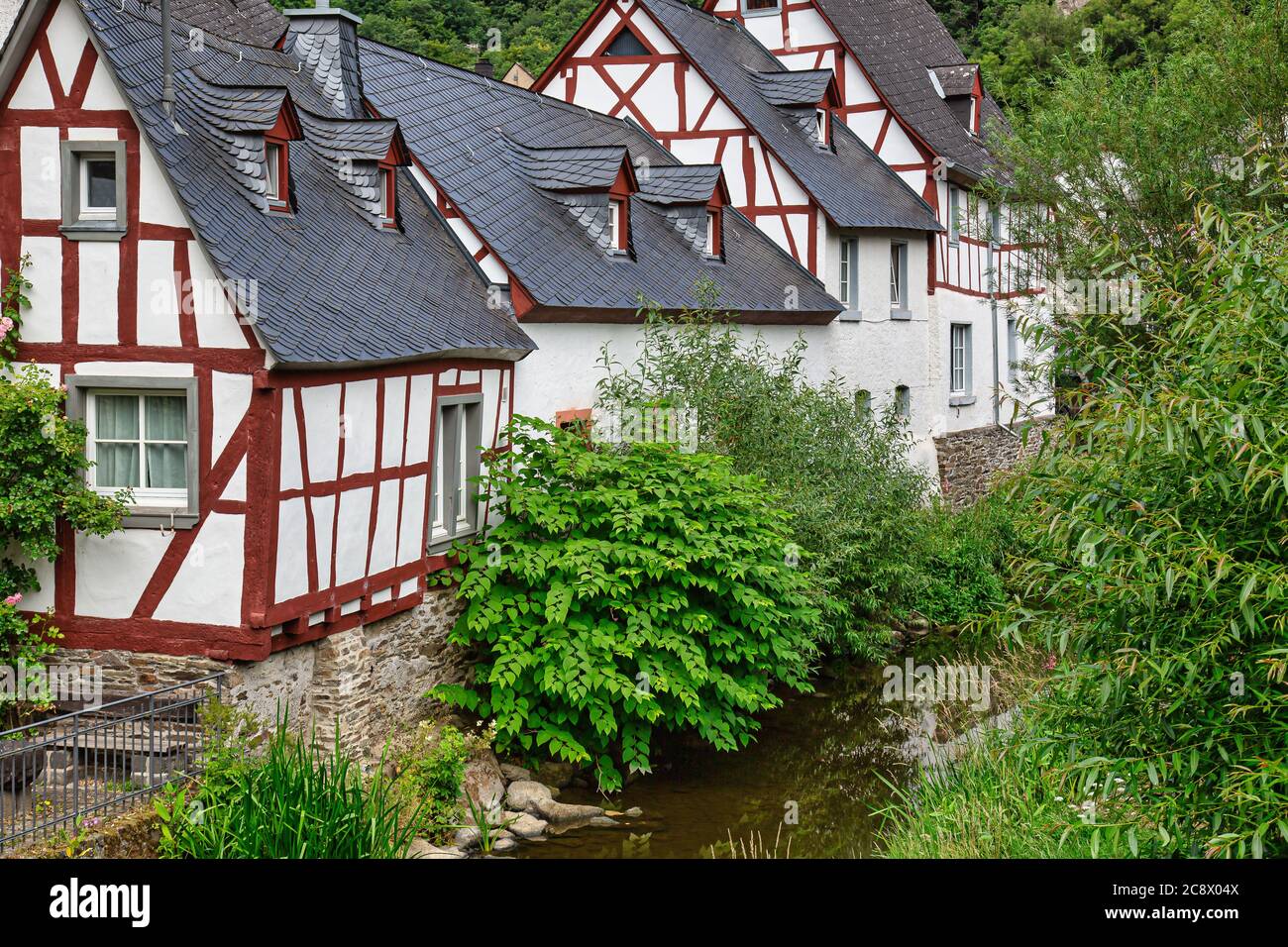 Rural scene with half-timbered houses beside a creek in a typical ...