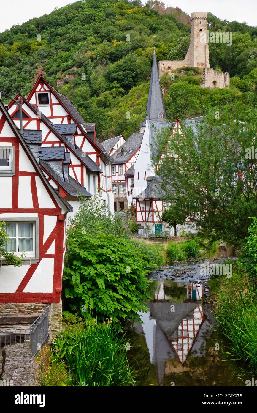 Rural scene with a ruin of an old castle above half-timbered houses in ...