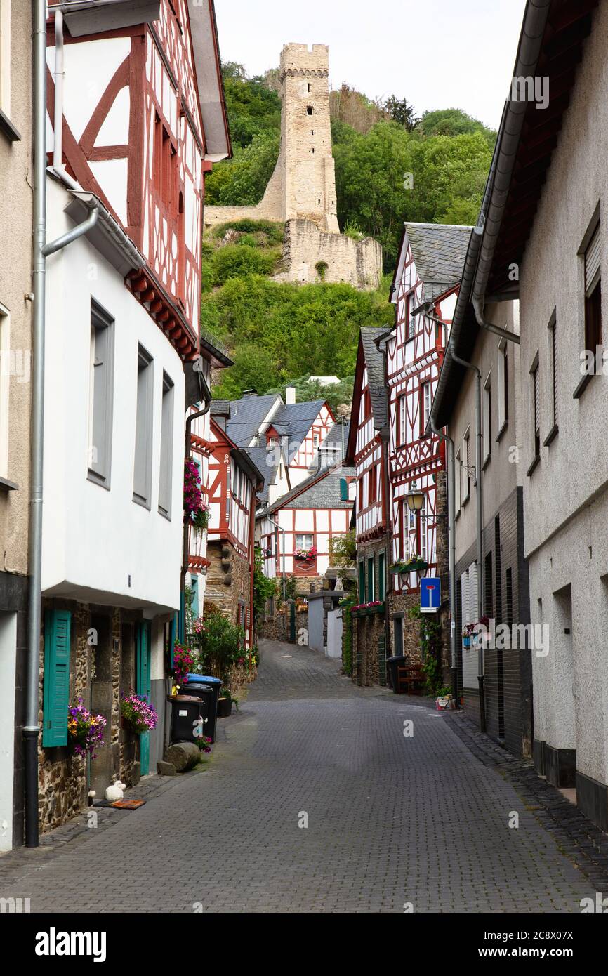 Rural scene with a ruin of an old castle above half-timbered houses in ...