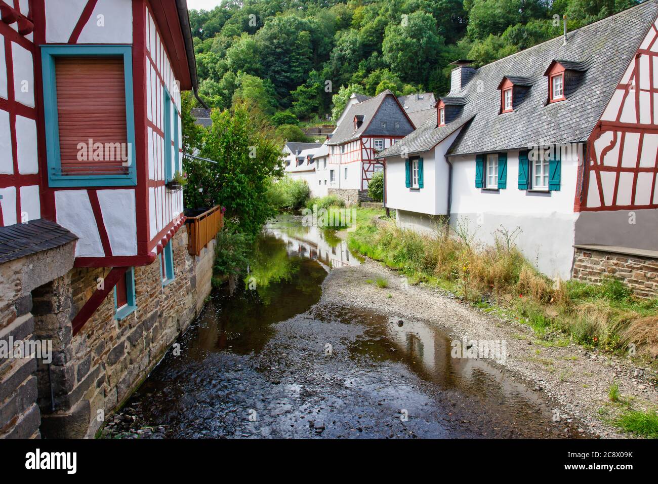 Rural scene with half-timbered houses beside a creek in a typical ...