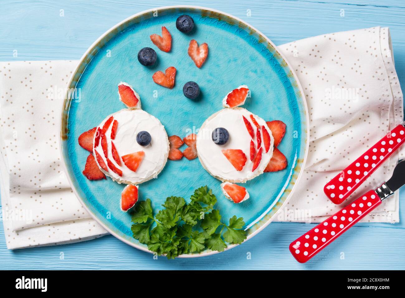 Funny toasts in a shape of kissing fishes, sandwich with cream cheese ...