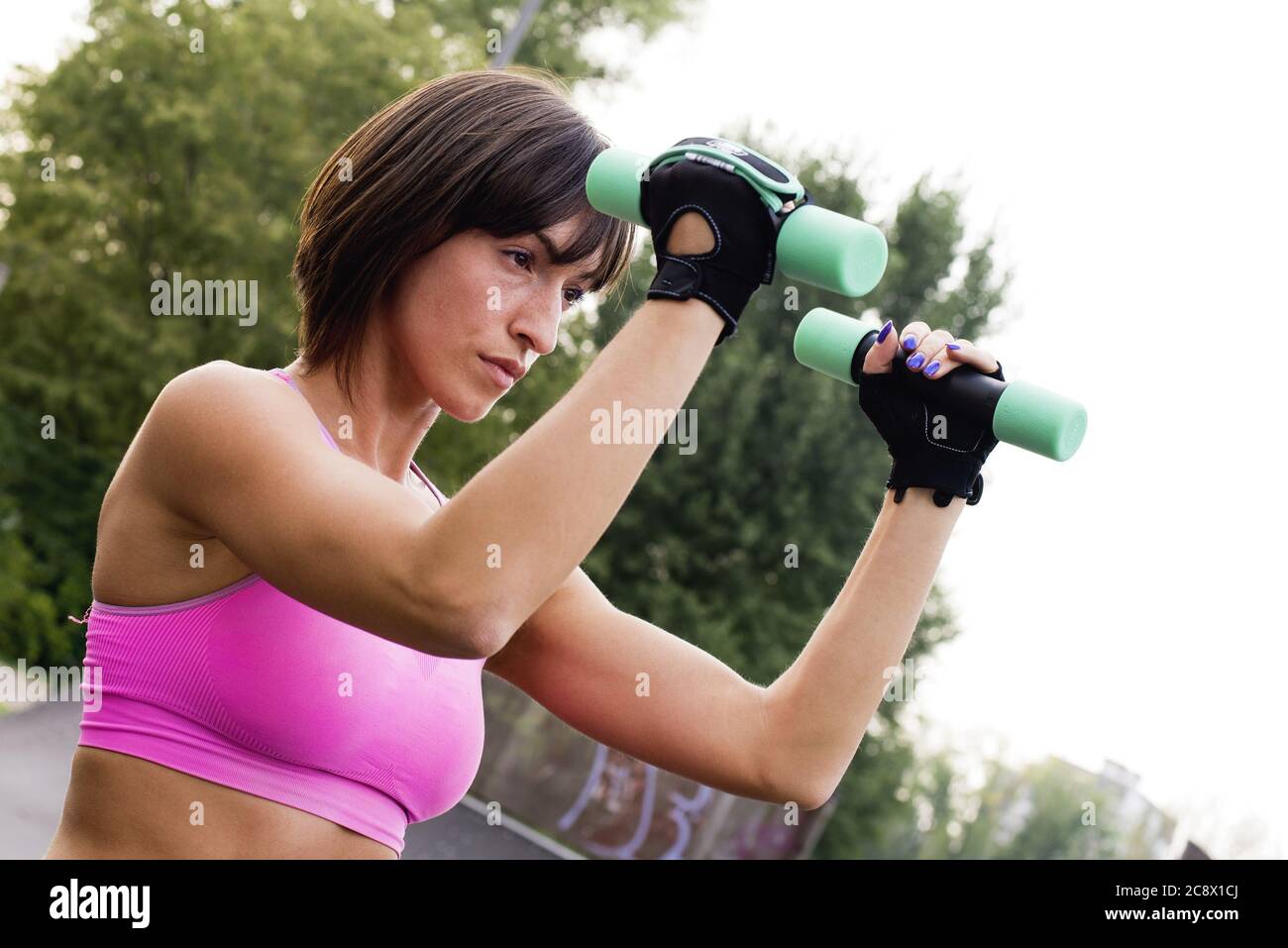 Shallow focus shot of a sporty Caucasian female doing a workout in the ...