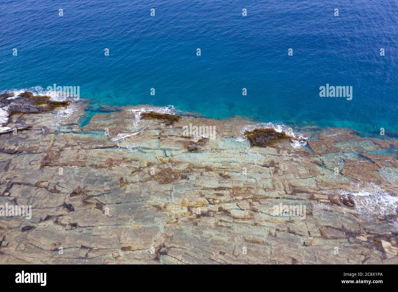 Aerial view of waves, rocks and transparent sea in Greece. Abstract ...