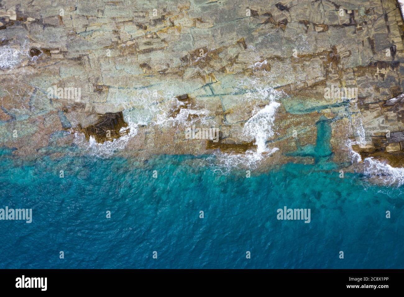 Aerial view of waves, rocks and transparent sea in Greece. Abstract ...