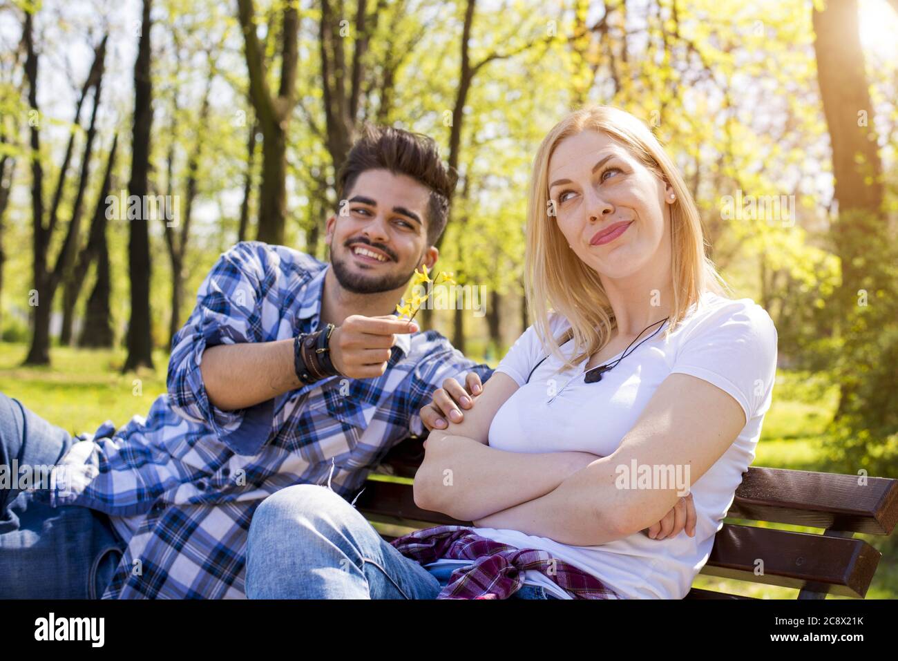 Attractive young couple flirting and having fun on a park bench Stock ...