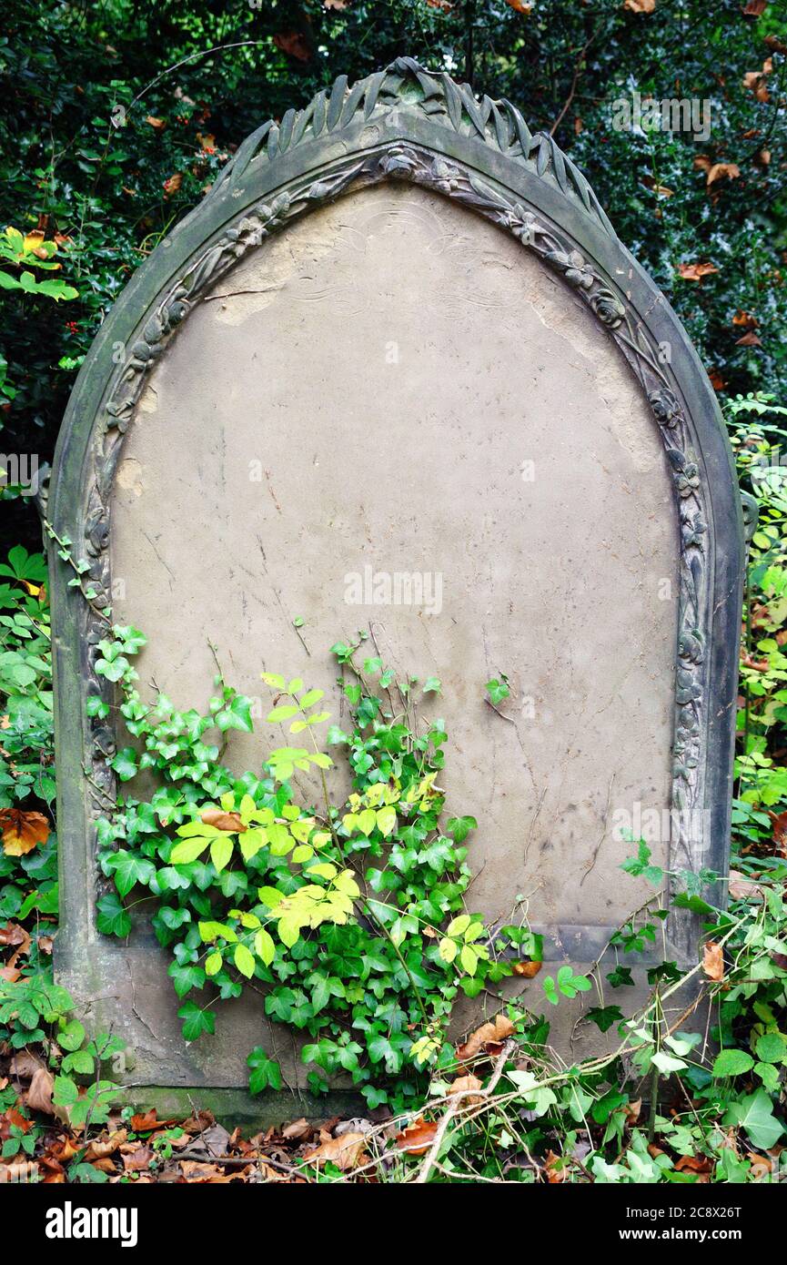 Blank tombstone grave of a recent funeral burial in an old cemetery ...
