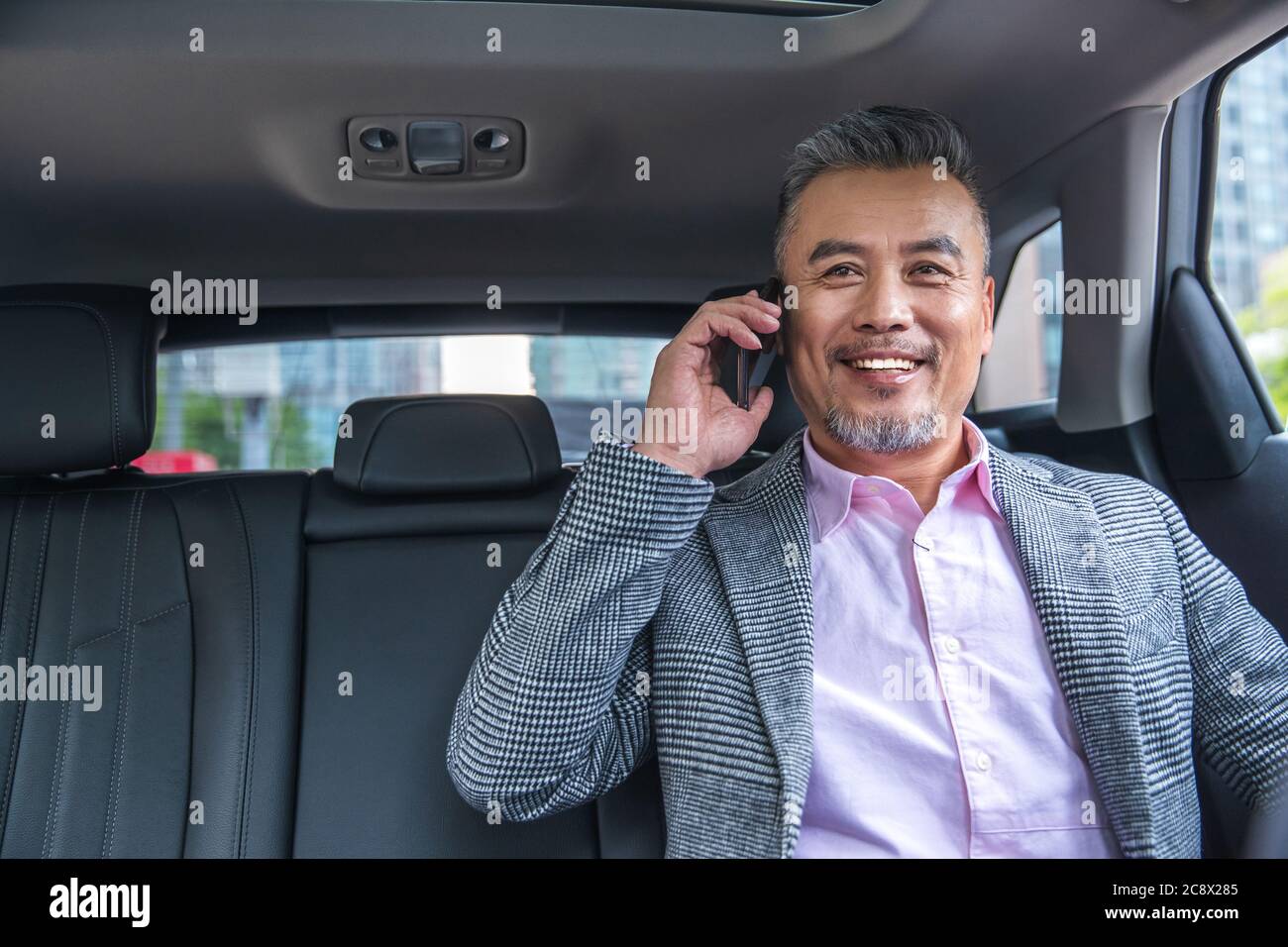 Business call middle-aged and old man sat in the car Stock Photo - Alamy