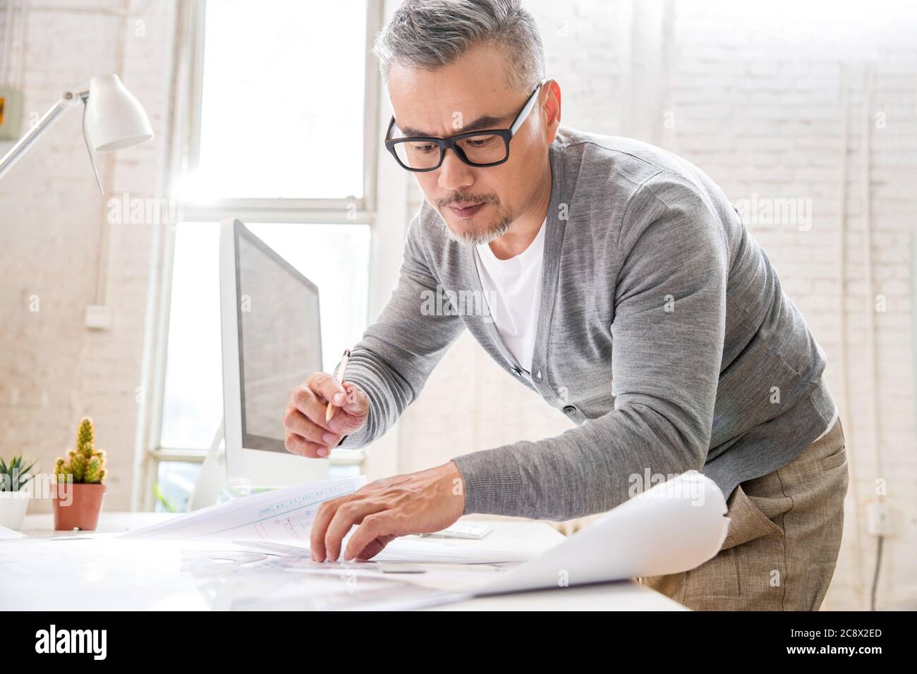 Painting drawings, a senior designer Stock Photo - Alamy