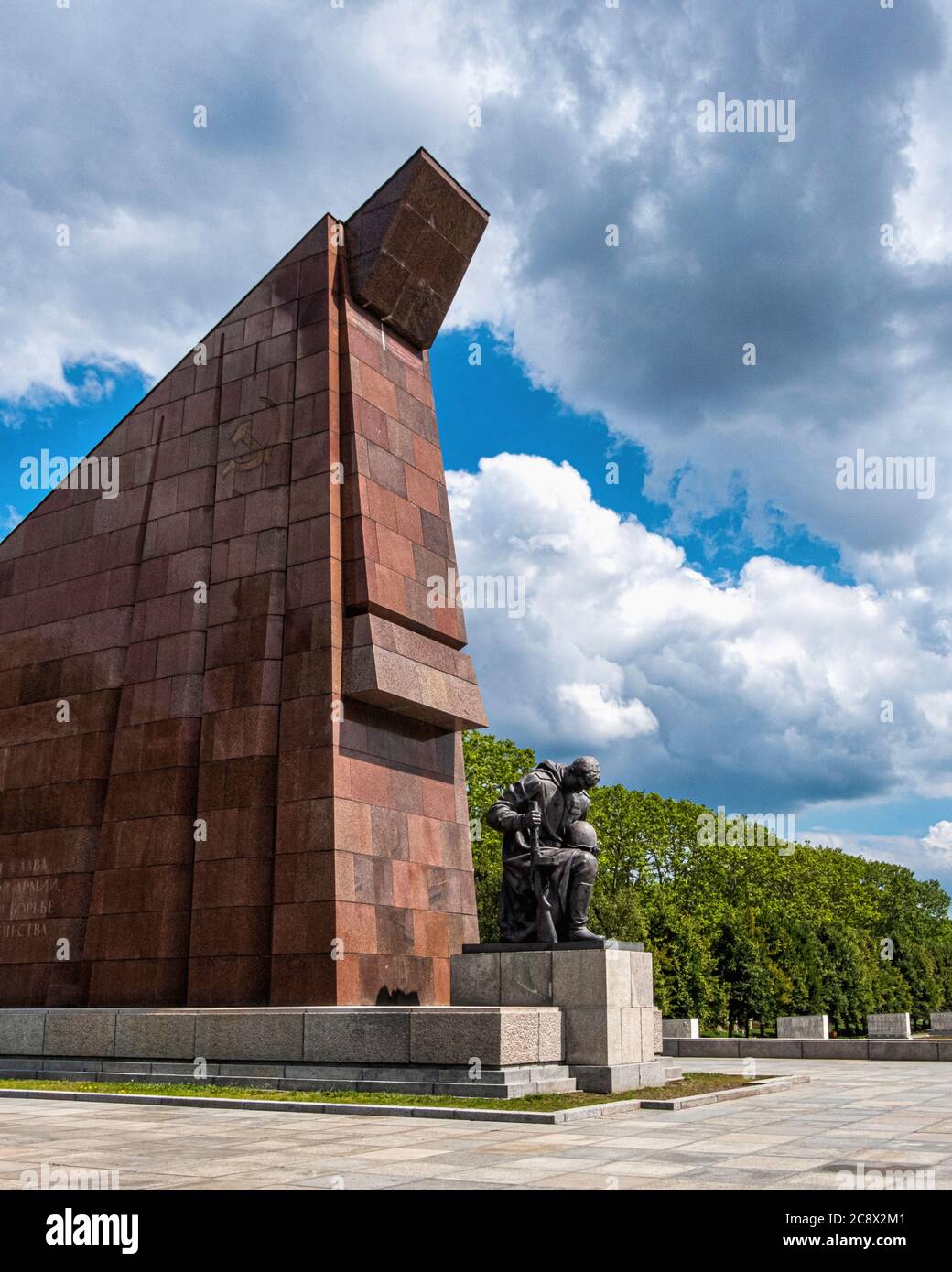 Bronze Kneeling soldier sculpture in front of abstract granite flag at ...