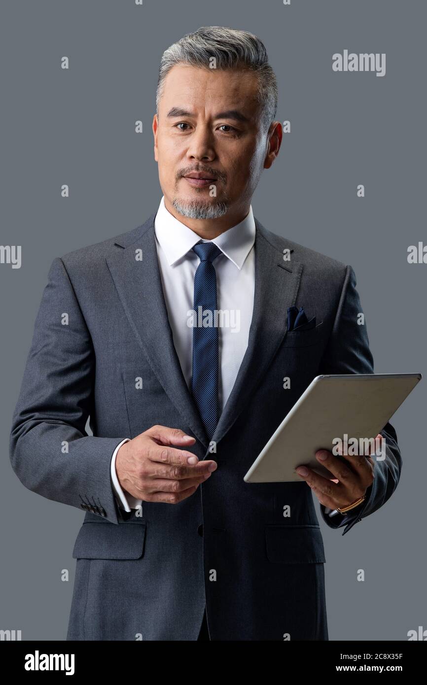 Holding a tablet business man Stock Photo - Alamy