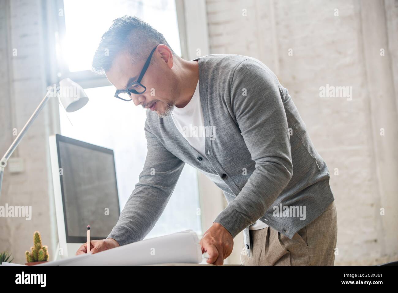 Painting drawings, a senior designer Stock Photo - Alamy
