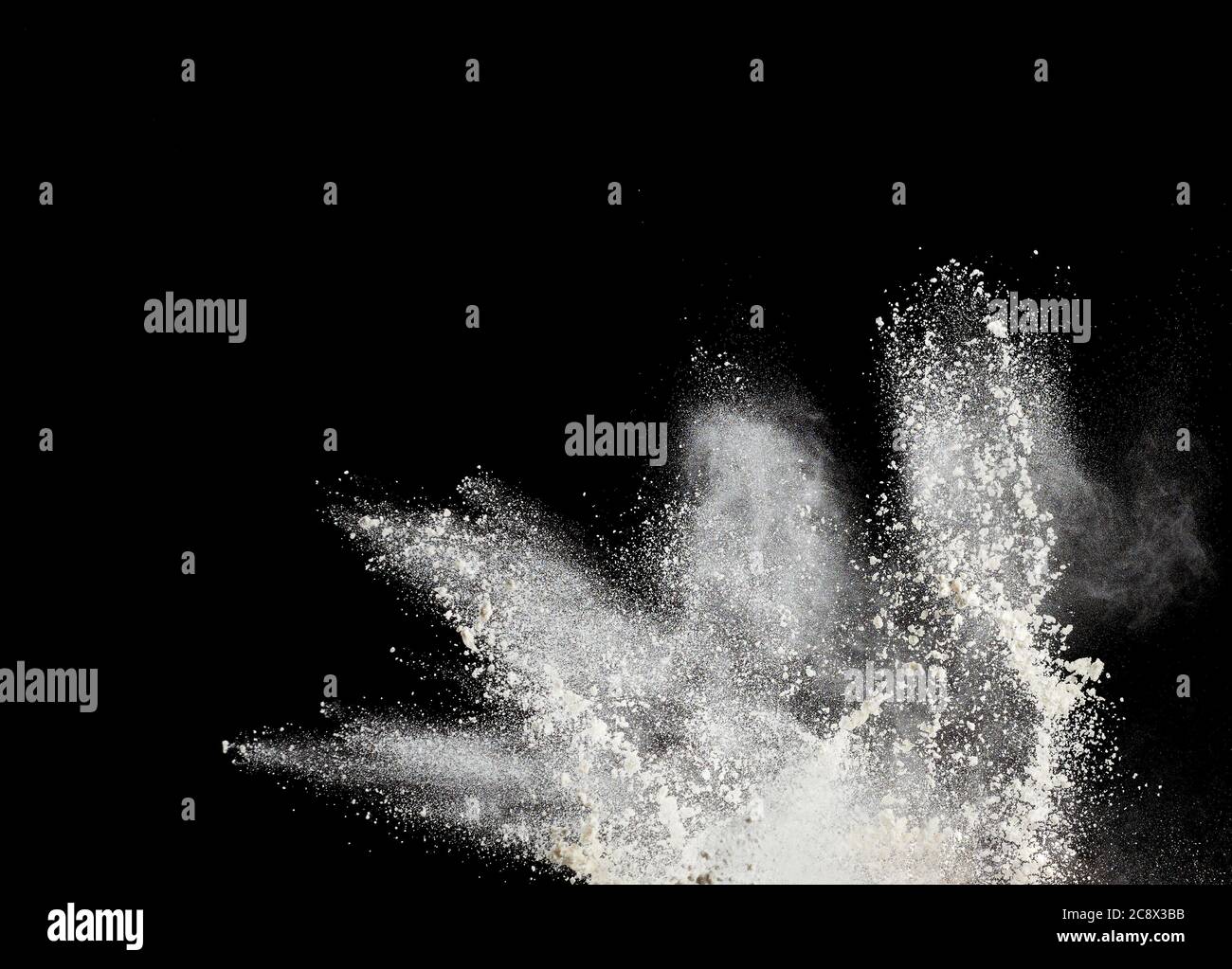 cloud of white wheat flour on a black background, particles fly in ...