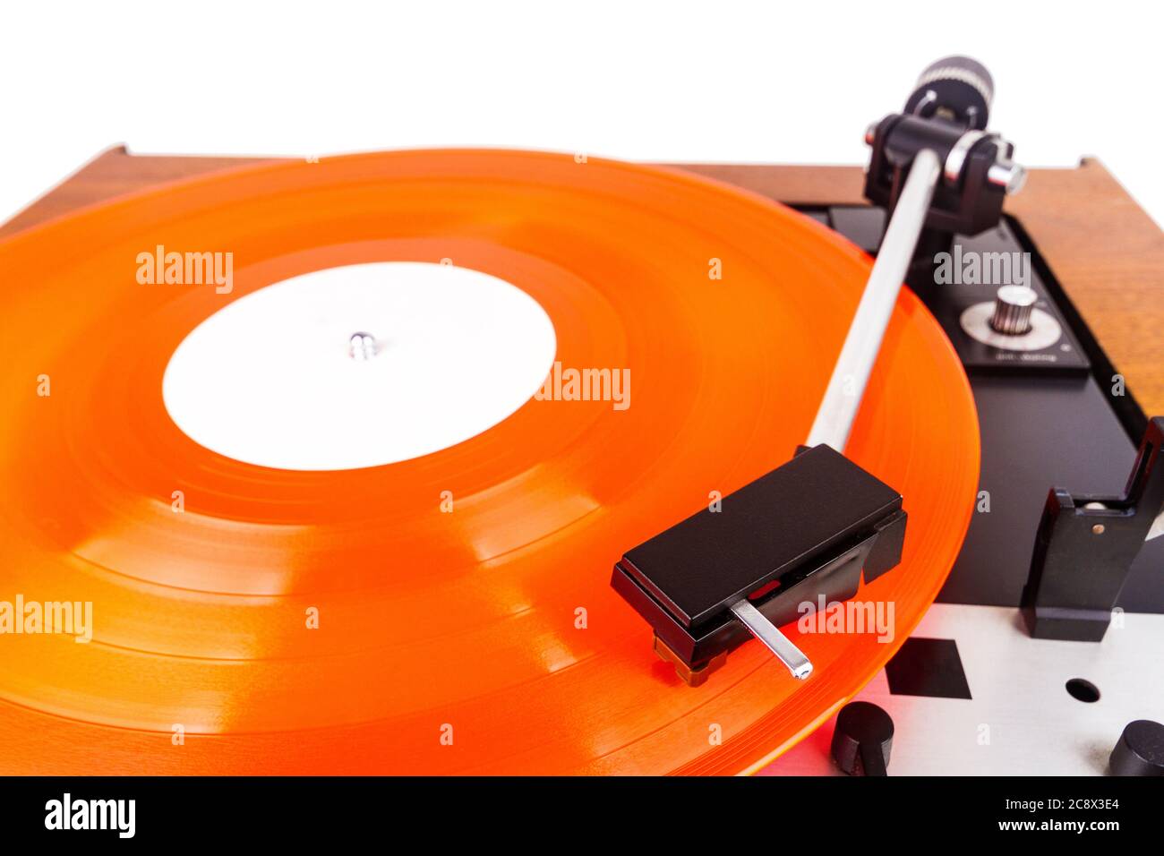 Vintage turntable with a red vinyl isolated on white. Wooden plinth ...