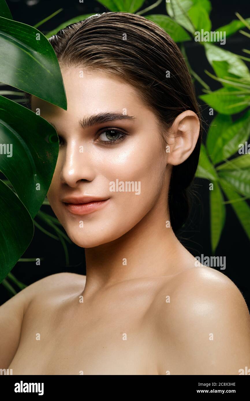 Woman's face and green leaves of palm tree clean skin healthy Stock ...