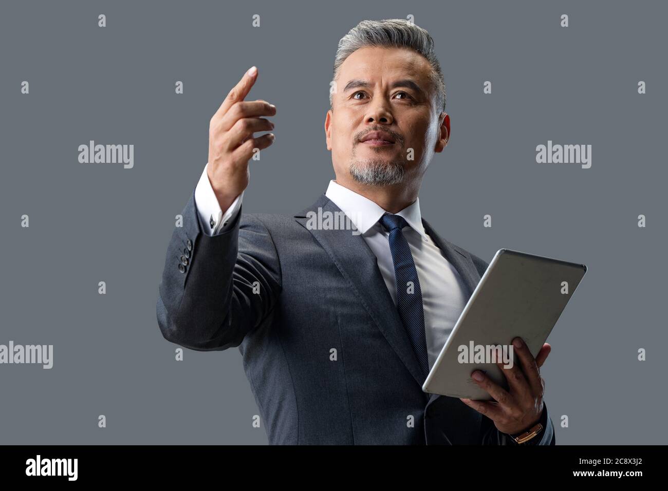 Holding a tablet business man Stock Photo - Alamy
