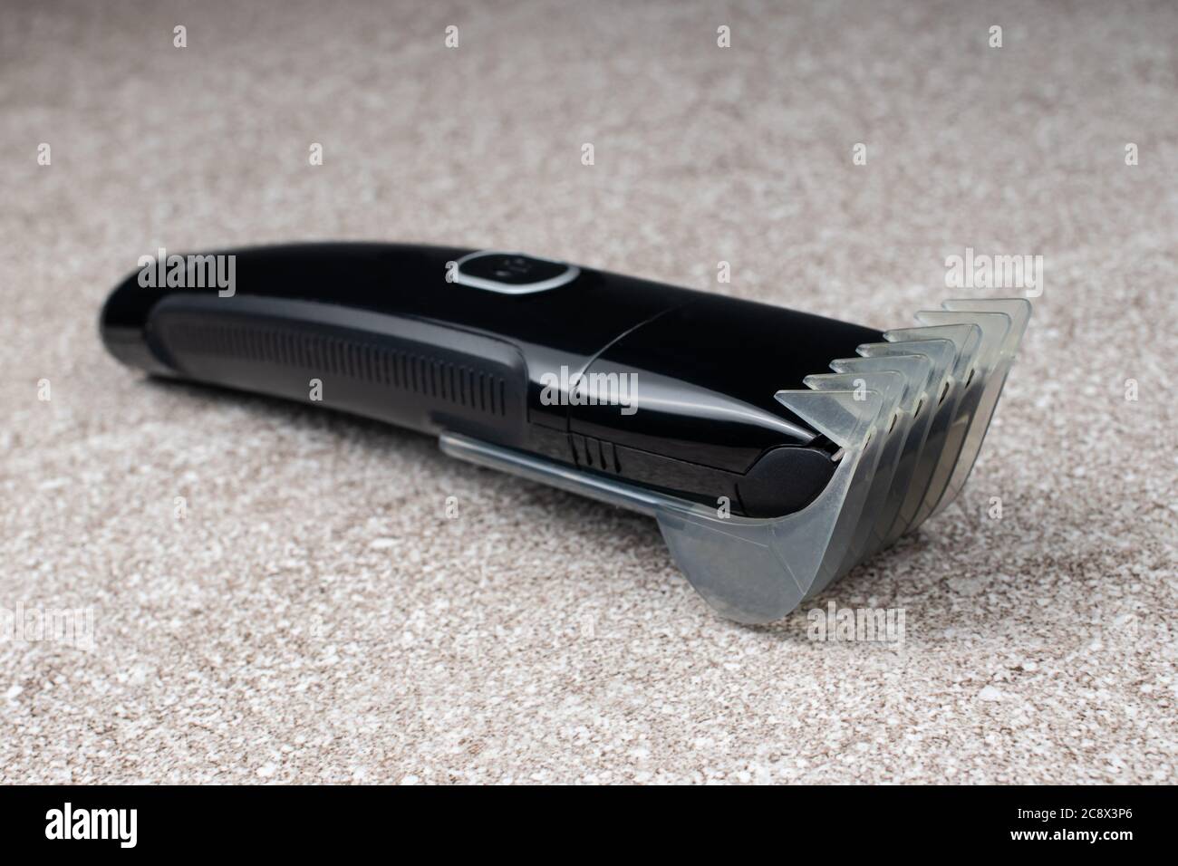 A razor with a trimmer for cutting and shaving hair, with a comb nozzle ...