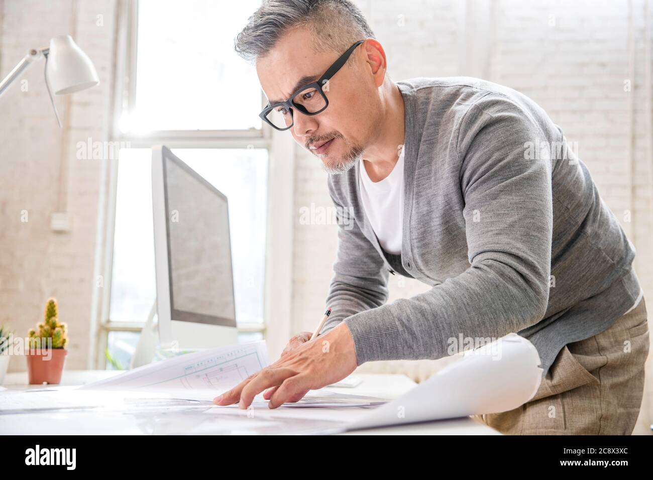 Painting drawings, a senior designer Stock Photo - Alamy