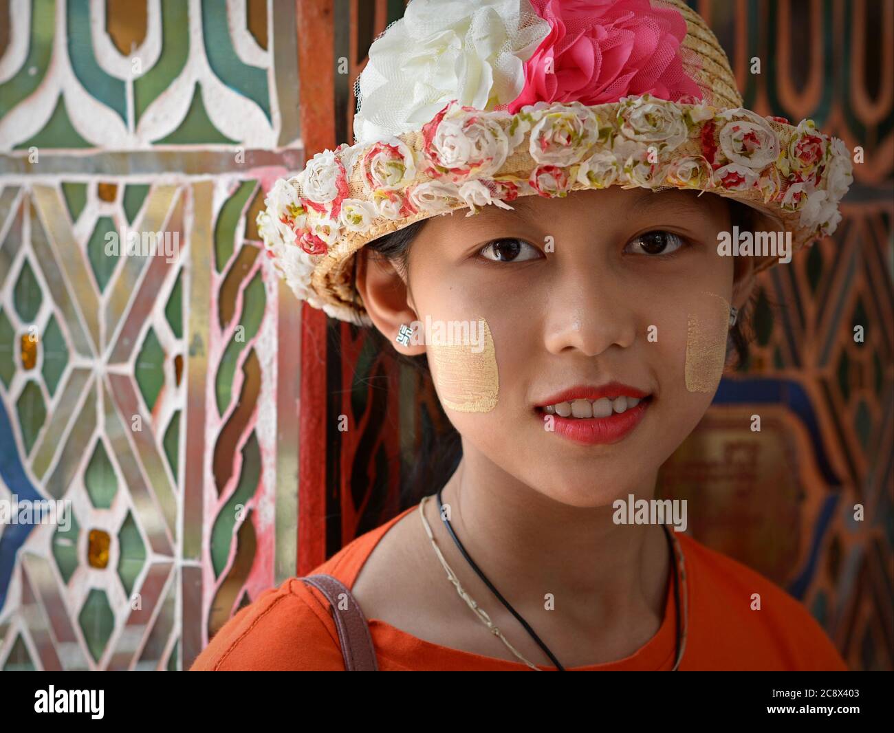 Pretty Burmese girl with natural thanaka face cosmetic on her cheeks ...