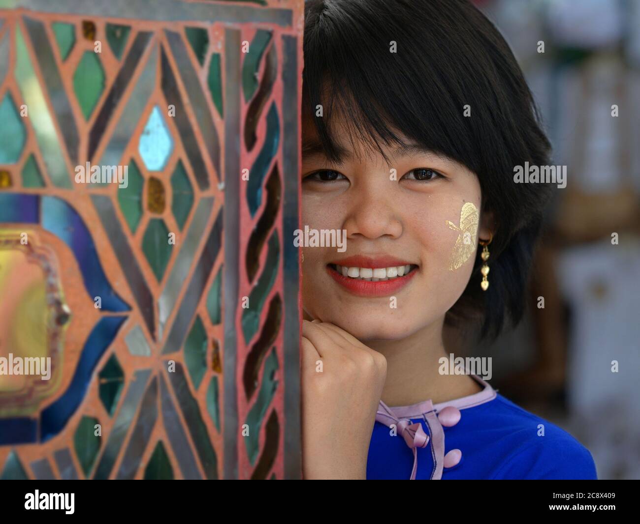 Pretty Burmese girl with natural thanaka face cosmetic on her cheeks ...