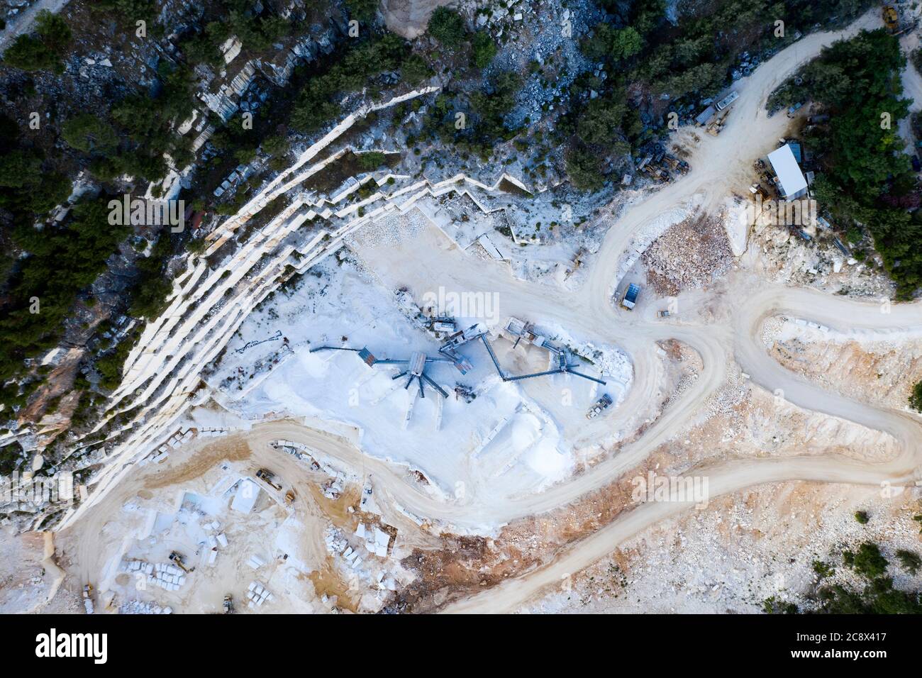 View of the rocky layers of a large and impressive open pit white ...