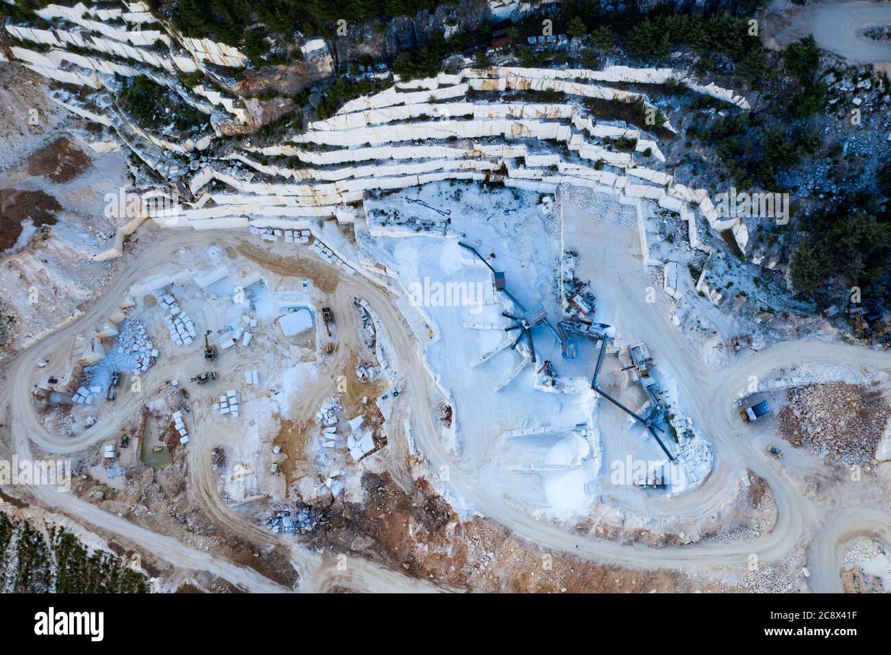 View of the rocky layers of a large and impressive open pit white ...