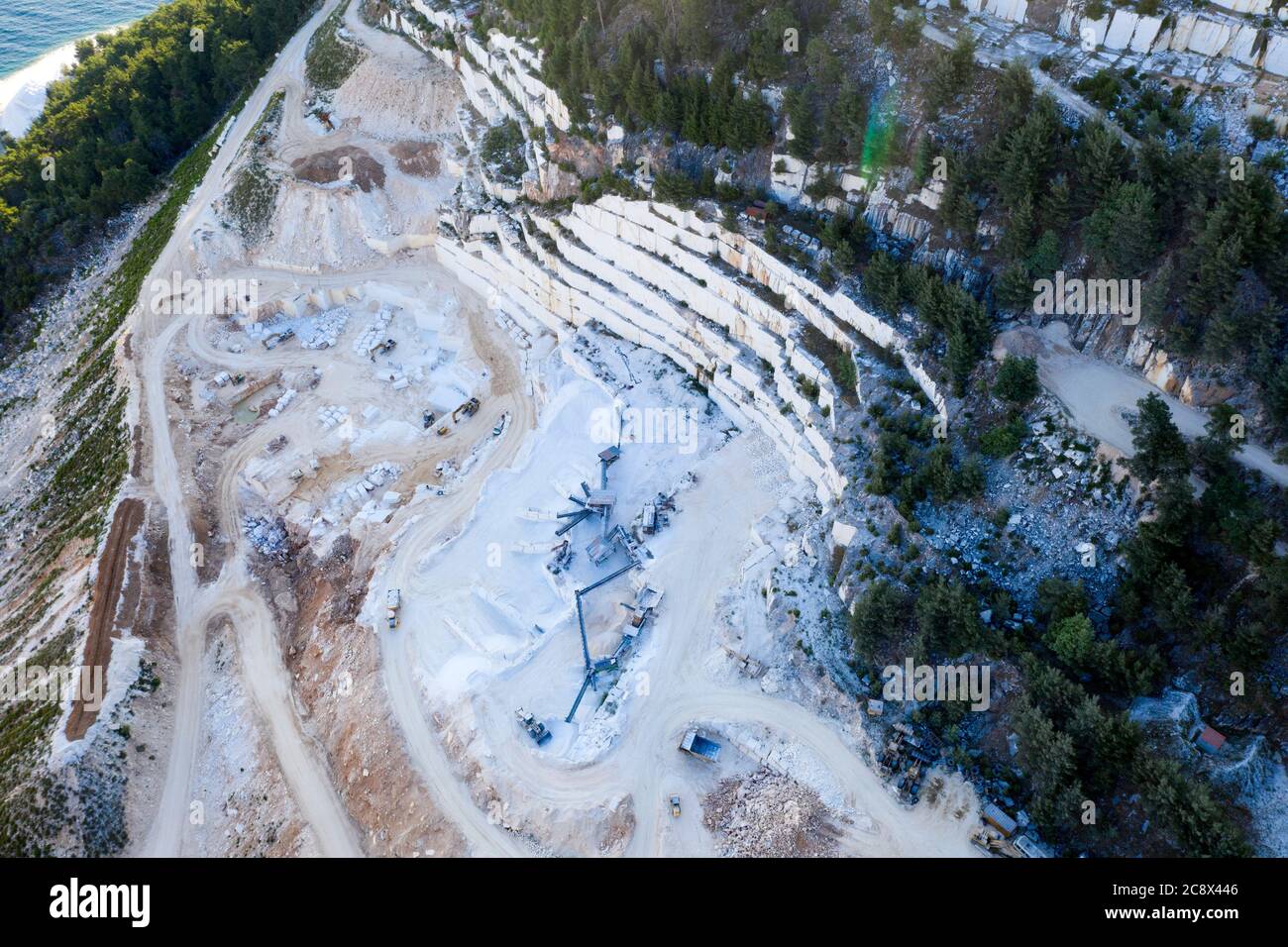 View of the rocky layers of a large and impressive open pit white ...