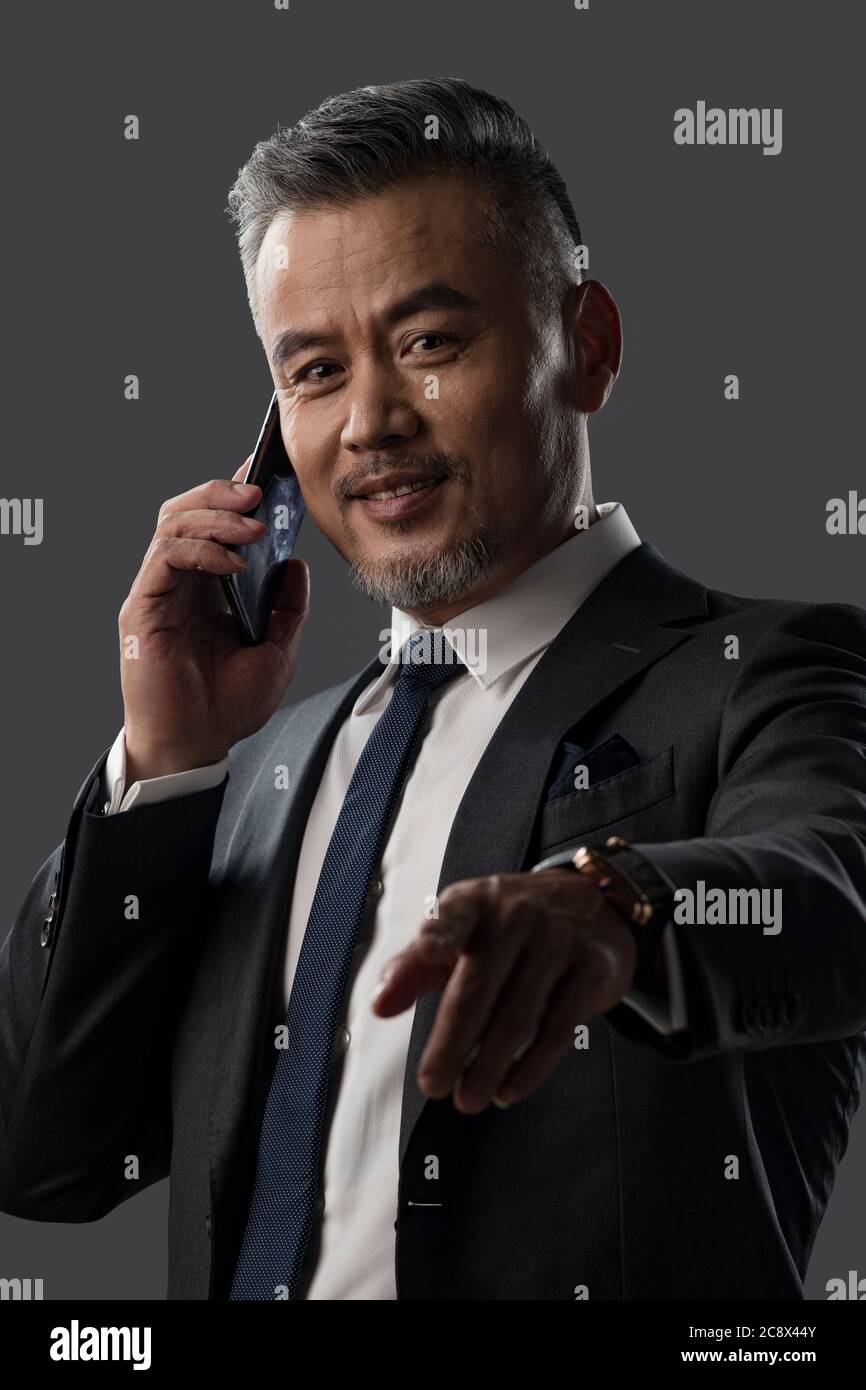 Holding a cell phone business men Stock Photo - Alamy