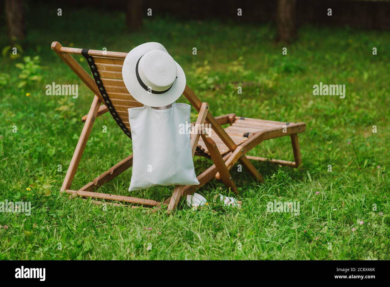 Wooden Deck Chair Under The Tree Stock Photo - Alamy