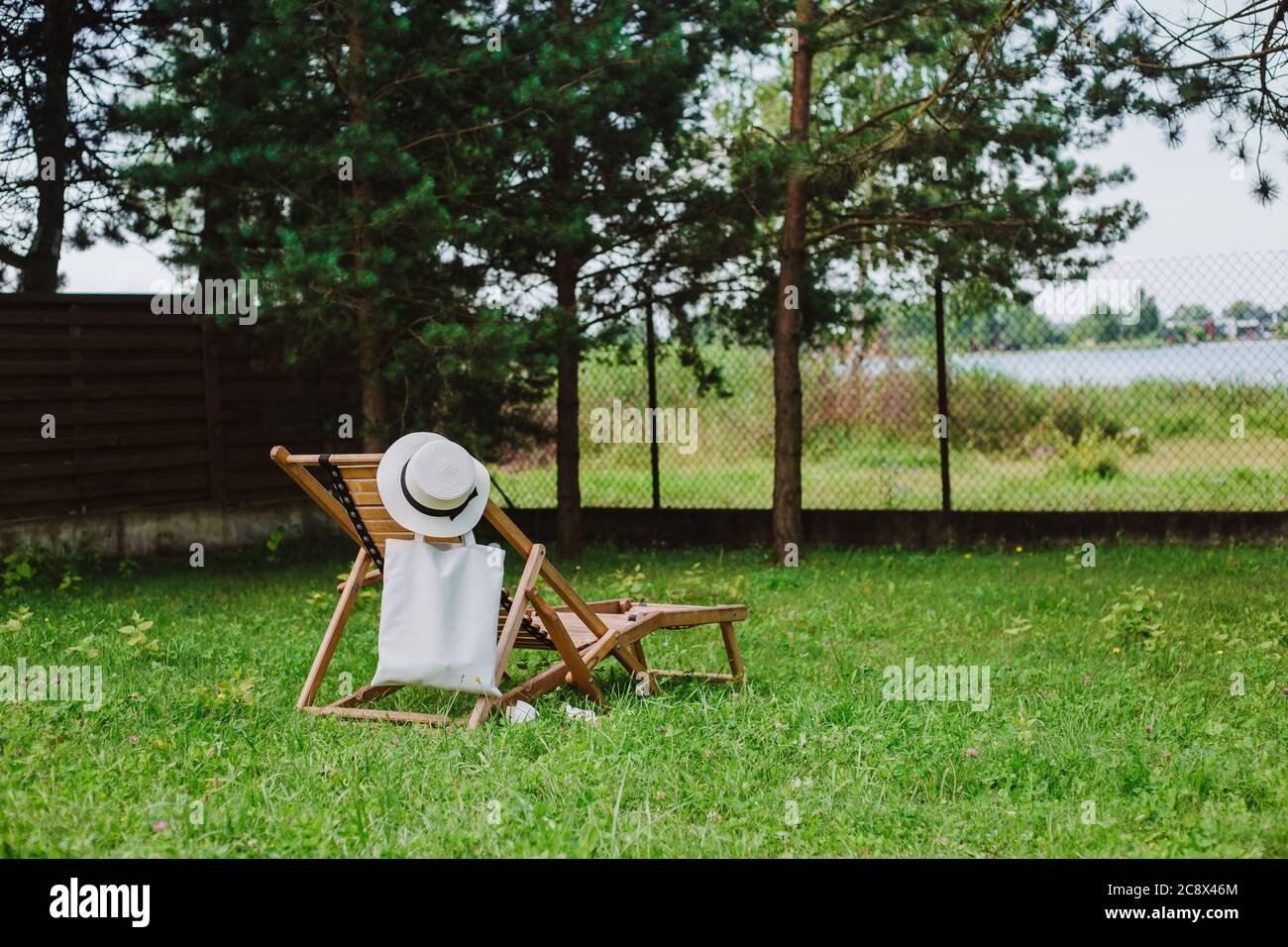 Wooden Deck Chair Under The Tree Stock Photo - Alamy