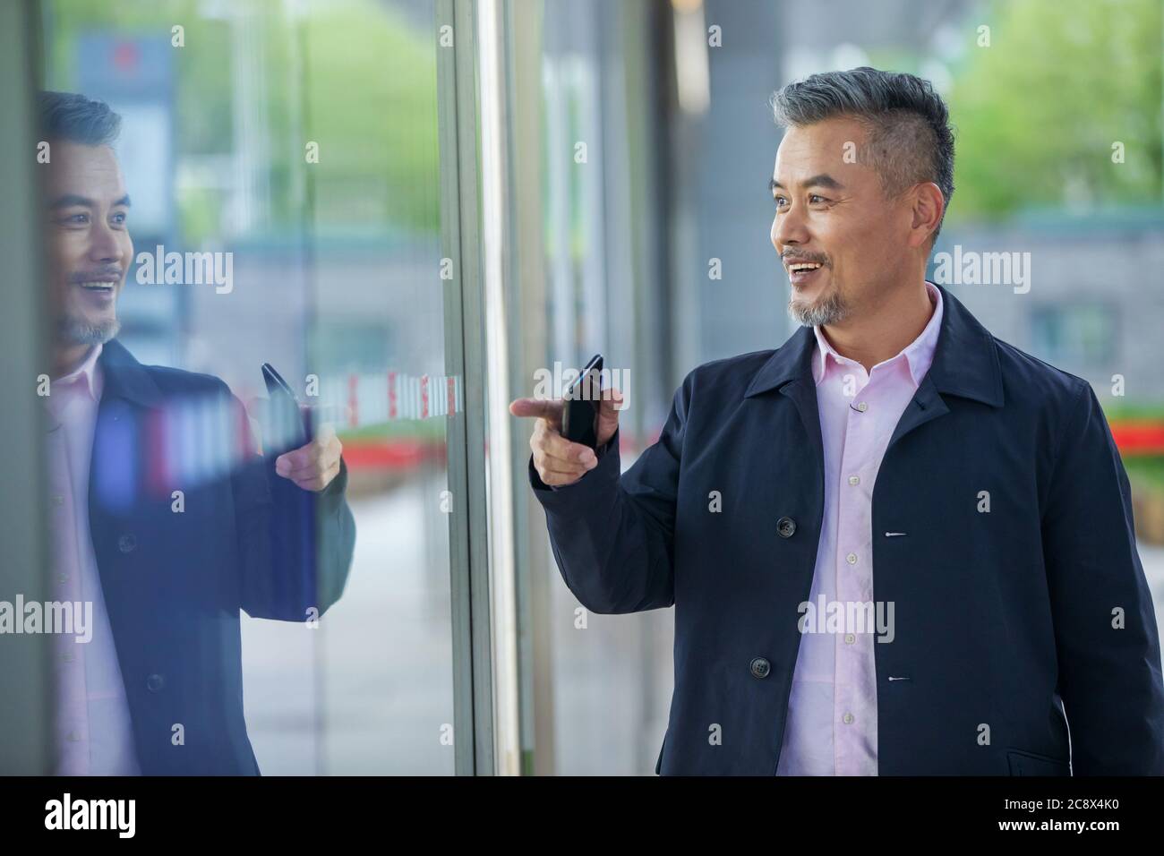 Business men watch window reflection of himself Stock Photo - Alamy